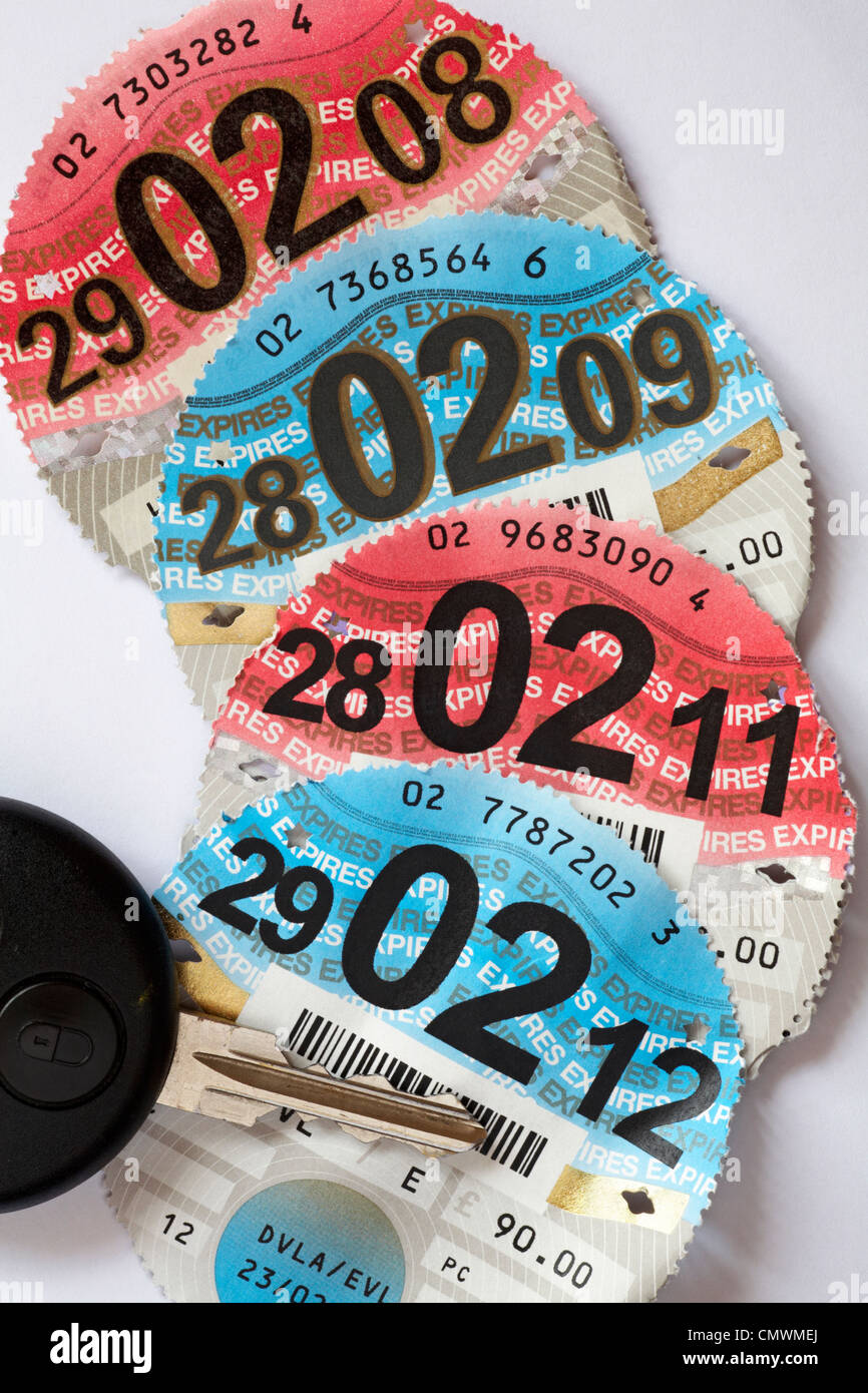 car tax discs for 2008, 2009, 2011, 2012 with car key set on white ...
