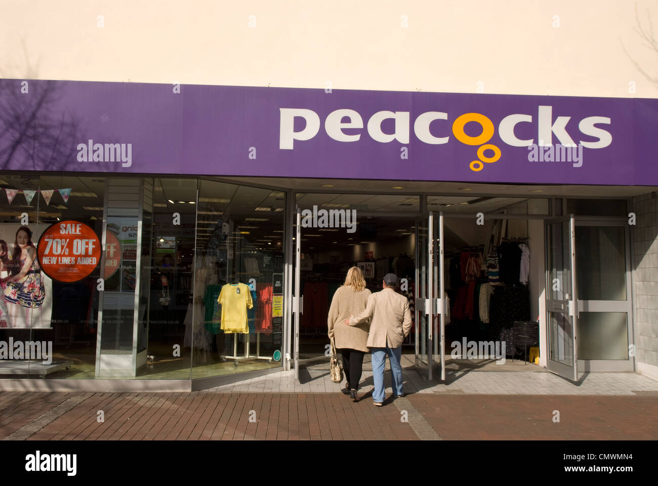 Couple entering Peacocks department store, High Street, Gosport ...