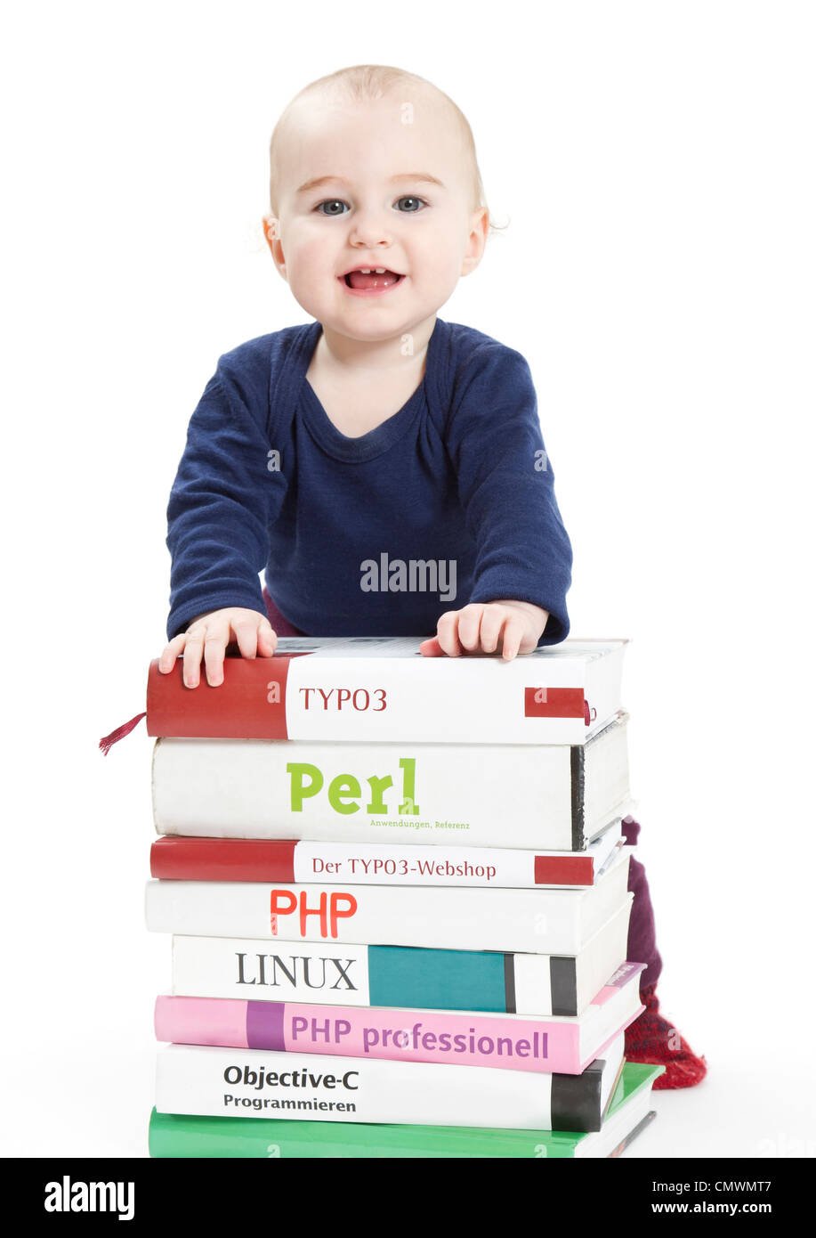 young child standing behind a stack of books. Isolated on white ...