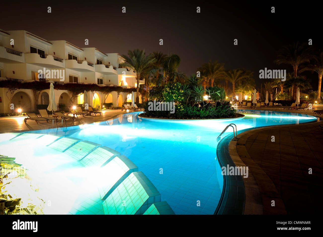 Hotel pool by night Stock Photo - Alamy