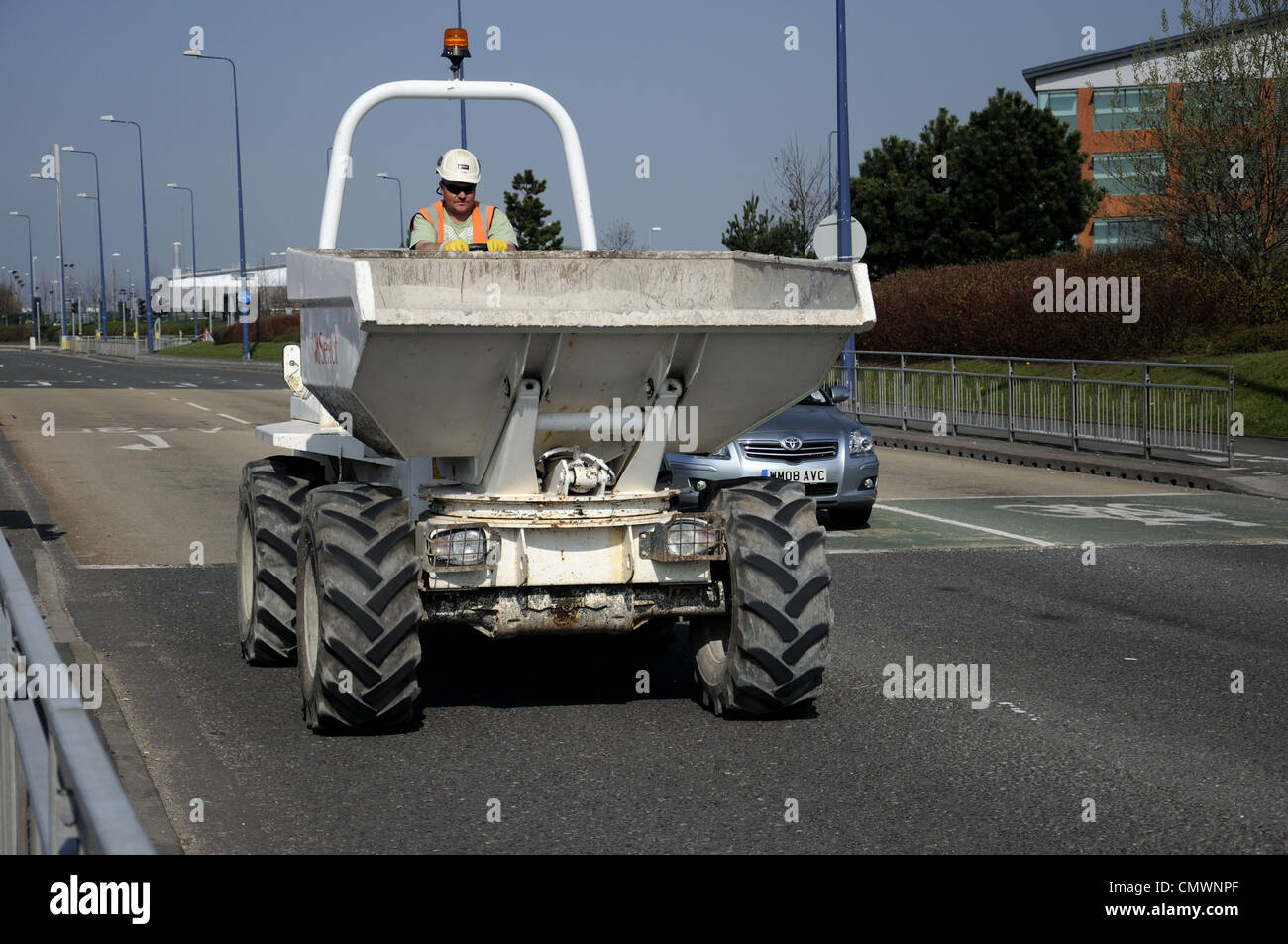 Construction worker in white tipper truck on main road Stock Photo - Alamy