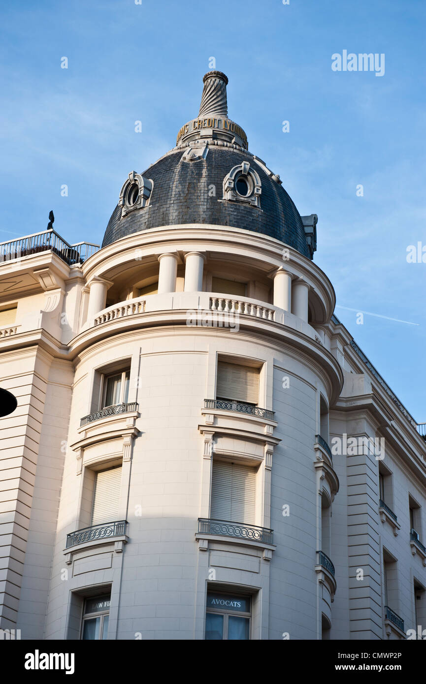 An attractive white, stone building in Cannes, France with a black dome ...
