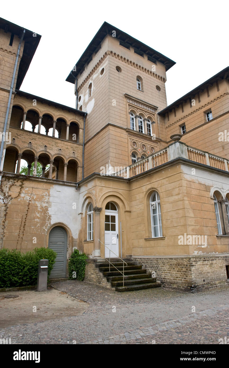 A full length shot of a sandy looking, textured, empire style building ...