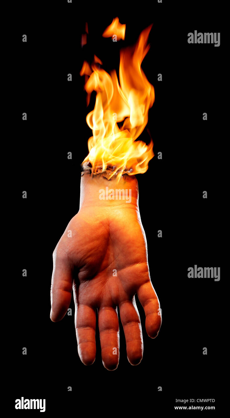 A Bizarre burning hand on black background Stock Photo - Alamy
