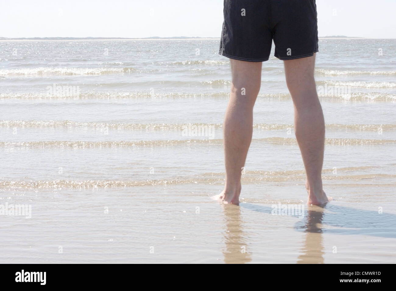 Man standing in the water Stock Photo - Alamy
