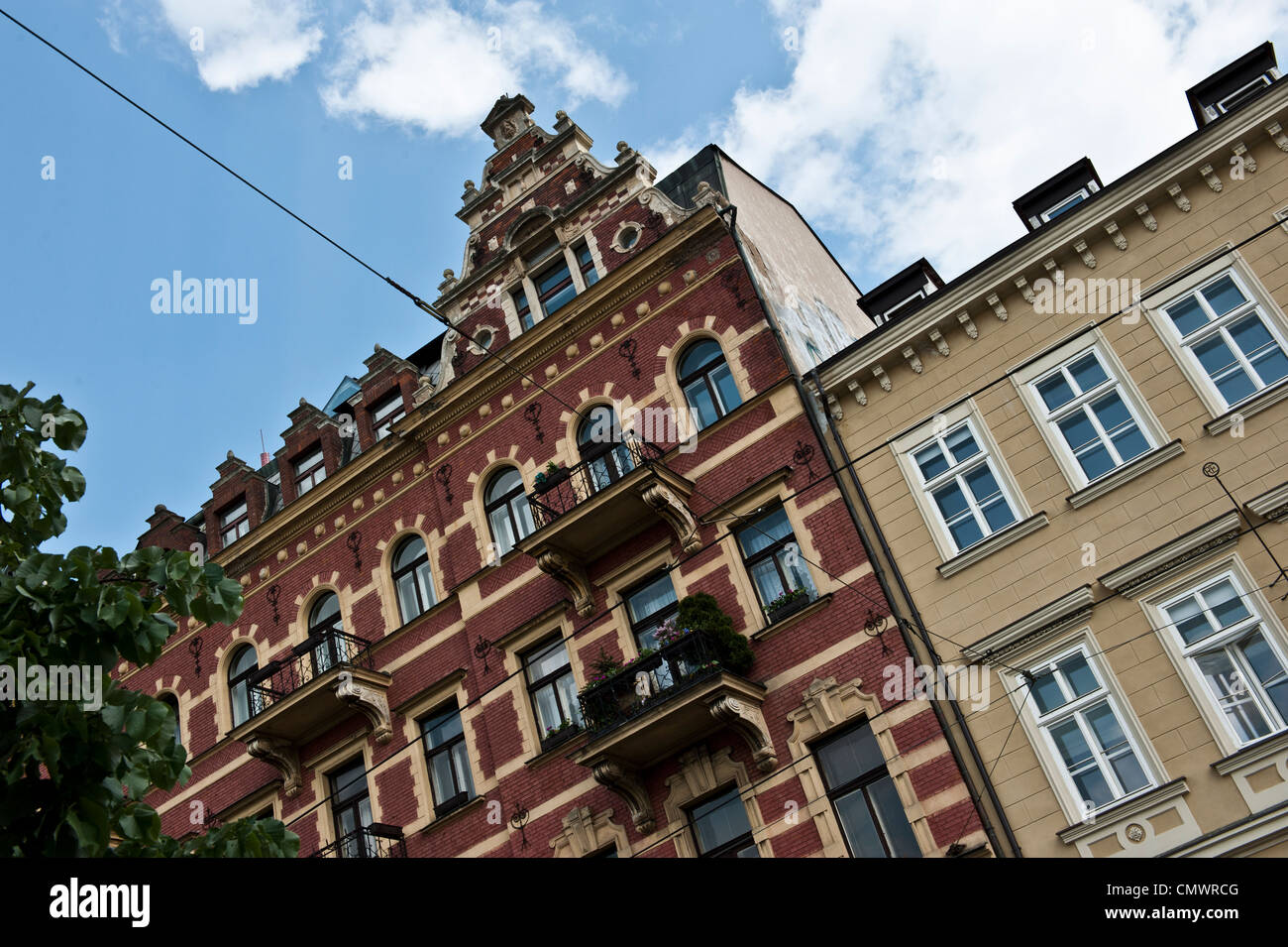 A wire line hanging in the air, across the street apartment buildings ...