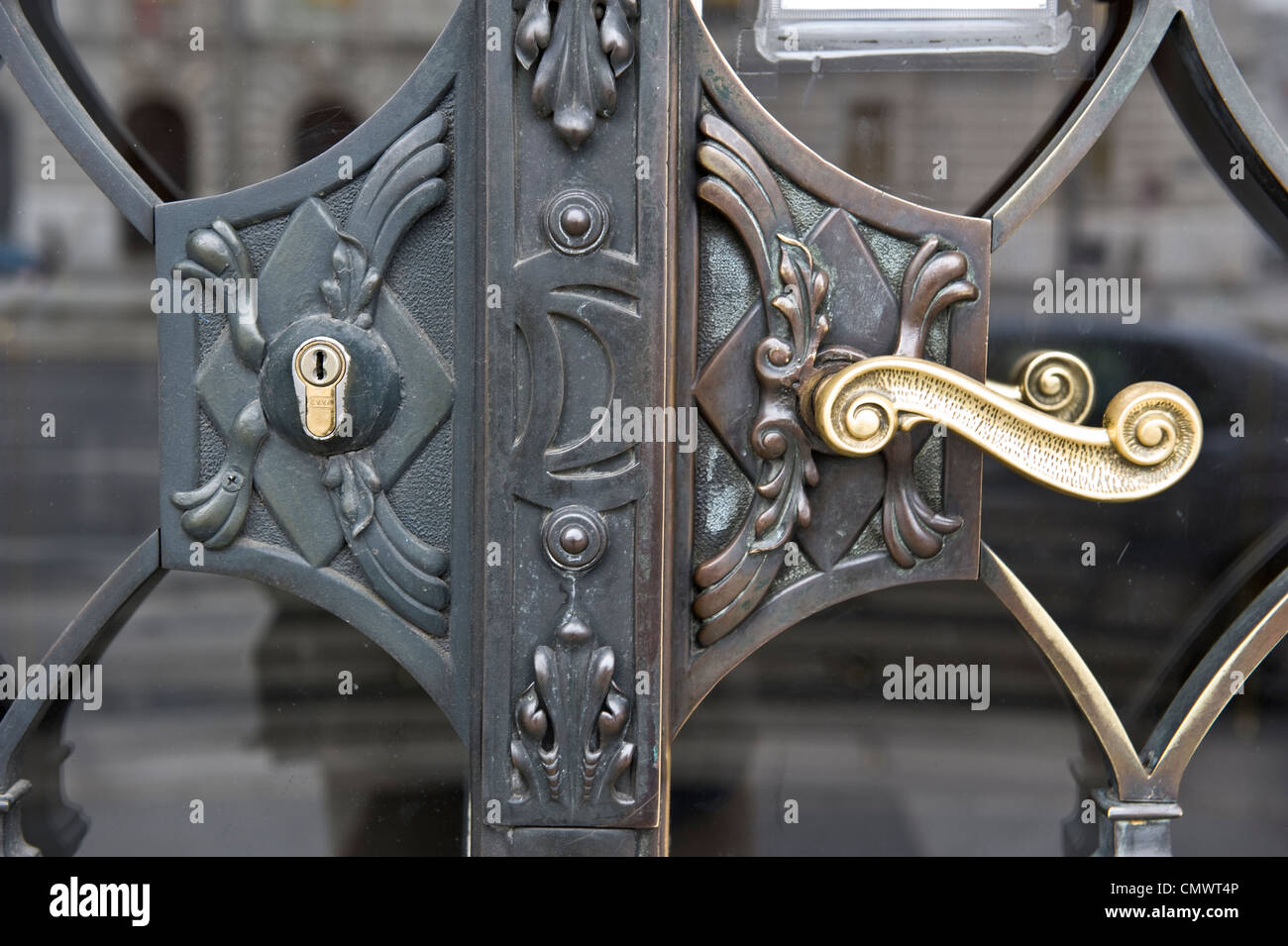 A fancy, gold lock and handle on an ornamental building Stock Photo - Alamy
