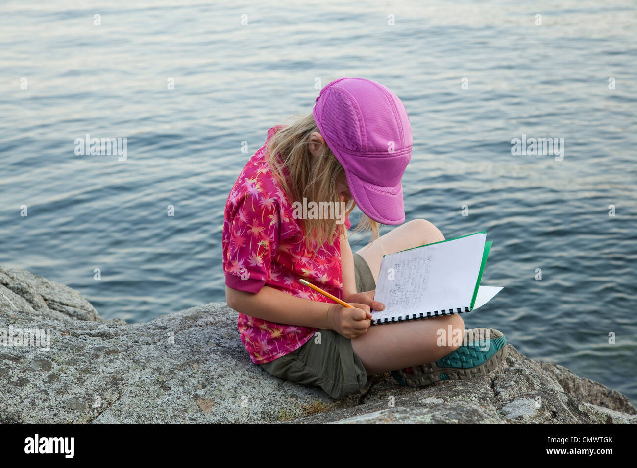 Grade 3 girl taking notes during a school outing, Keats Island, British ...