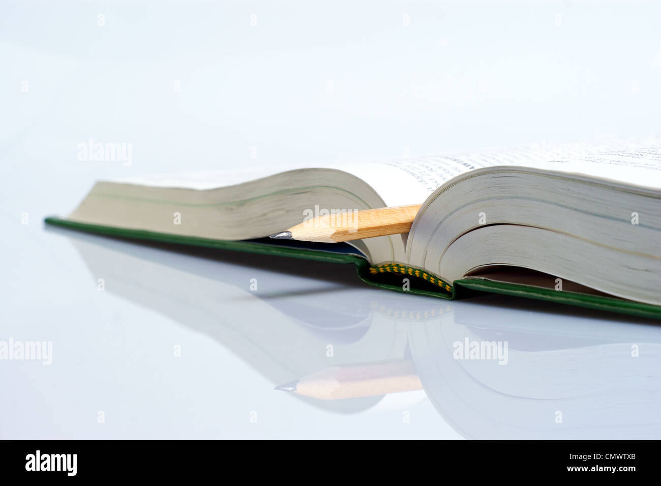 open dictionary, book with a sharp pencil, white background Stock Photo ...