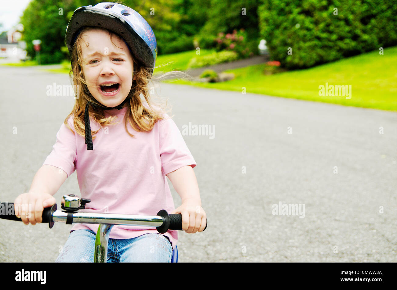 Girl riding bike and crying, Otterburn Park, Quebec Stock Photo - Alamy
