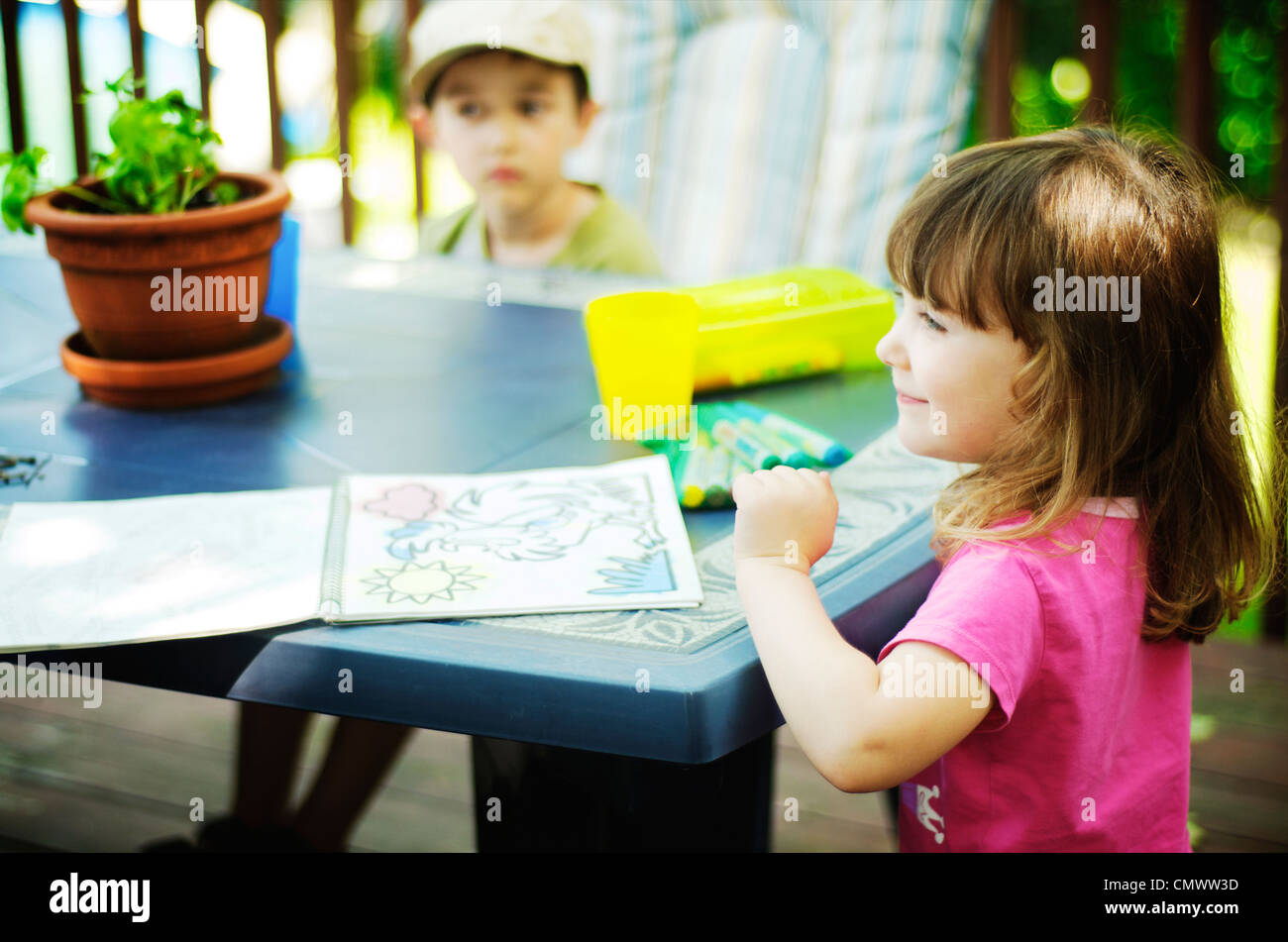 Kids with coloring books on table outside, Otterburn Park, Quebec Stock ...