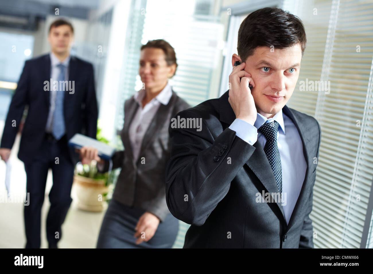 A handsome businessman calling by the phone in office Stock Photo - Alamy