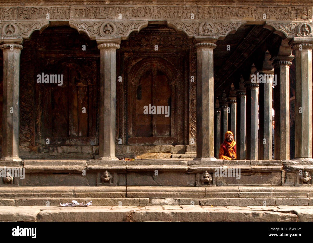 Hindu man sitting outside a temple in Patan Durbar Square Stock Photo ...