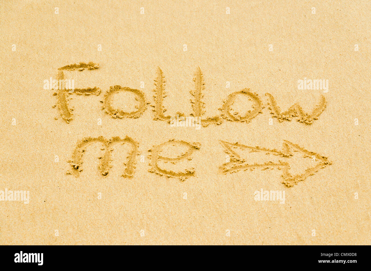 word " follow me " on the yellow sand of the sea Stock Photo - Alamy