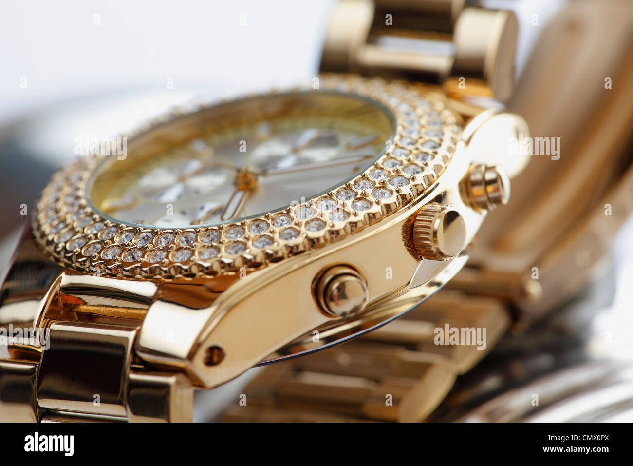 Golden wrist watch with jewels, close up Stock Photo - Alamy