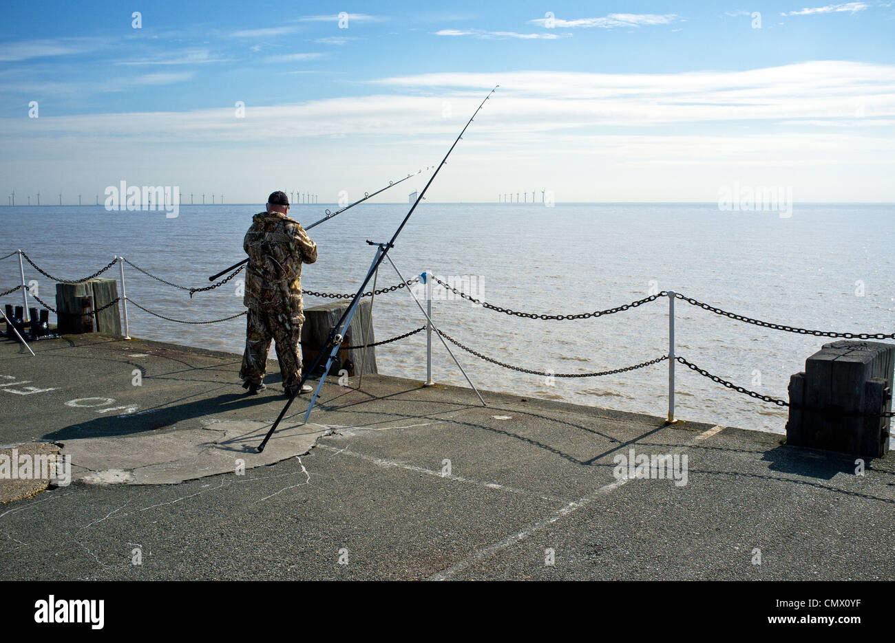An angler fishing on Clacton Pier Stock Photo - Alamy