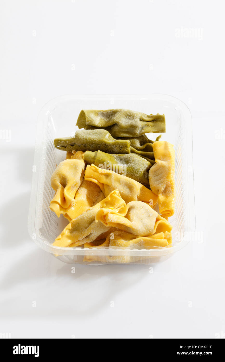 Candy shape pasta in plastic tray on white background Stock Photo - Alamy