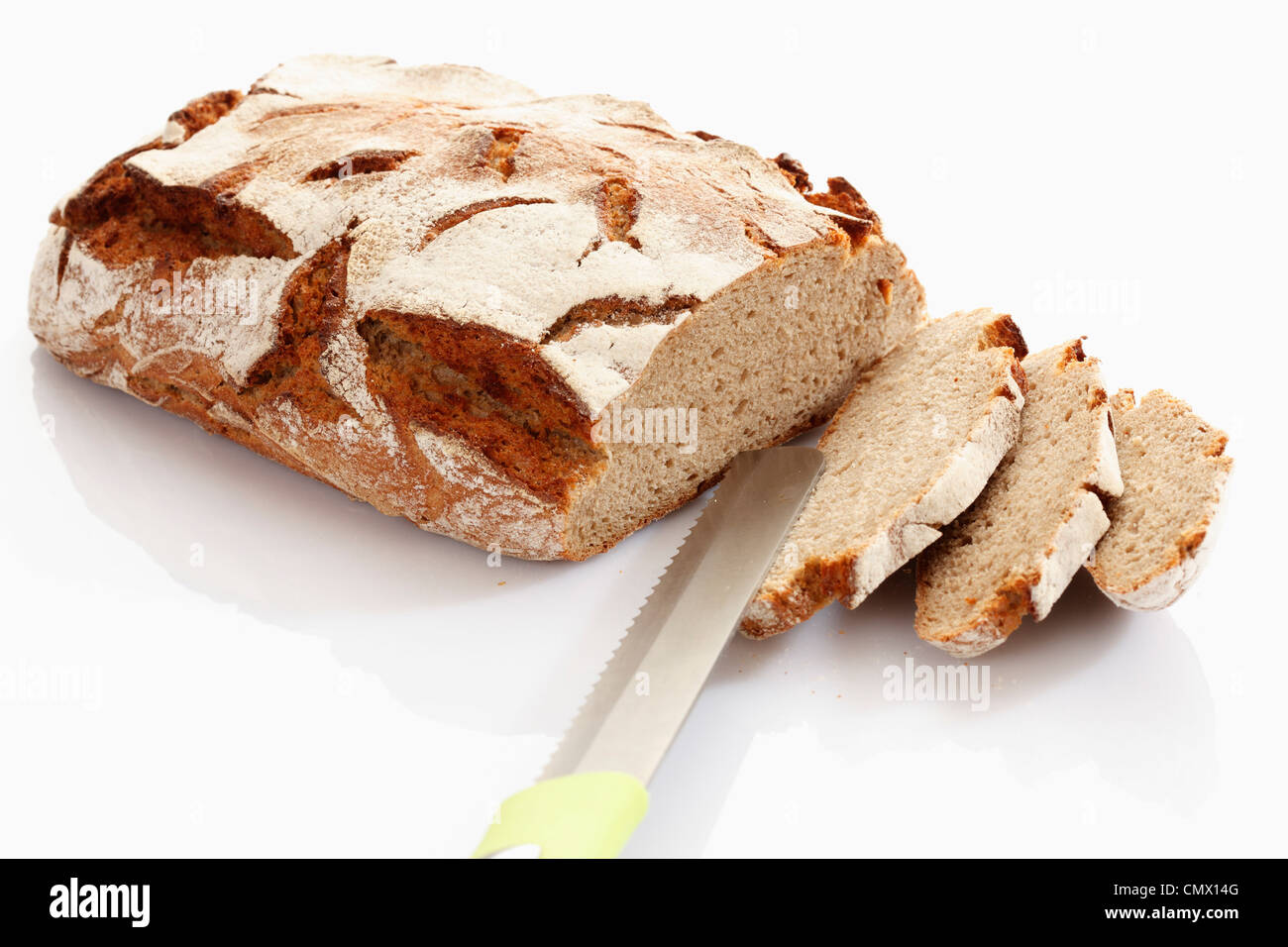 Rye bread loaf with slice on white background, close up Stock Photo - Alamy