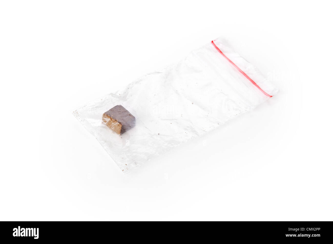 Piece of hashish in pocket closeup on white Stock Photo - Alamy