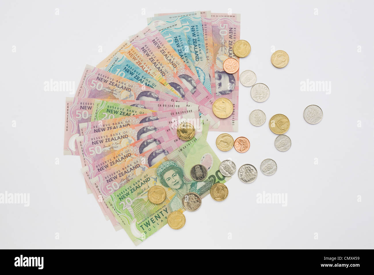 Variety of notes and coins on white background Stock Photo - Alamy