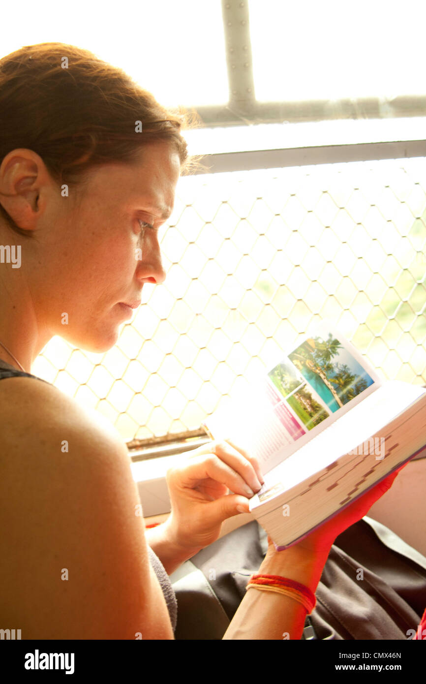 girl traveling reading a guide book Stock Photo - Alamy