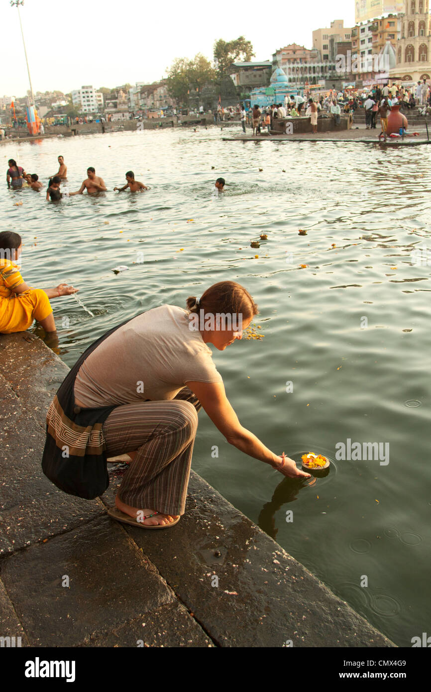 prayer offerings into Indian river Stock Photo - Alamy