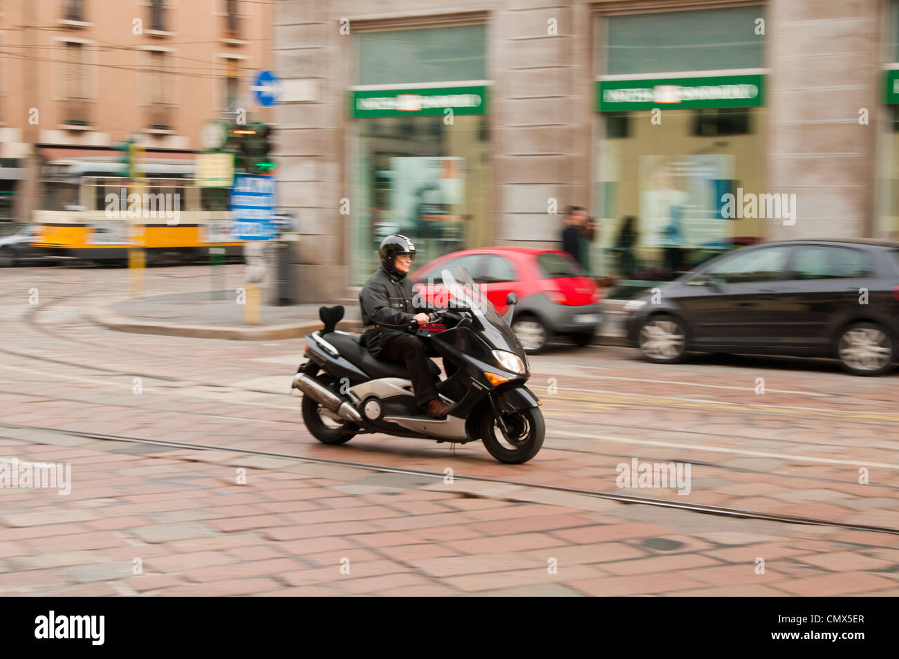Moped /scooter rider in Milan Stock Photo - Alamy