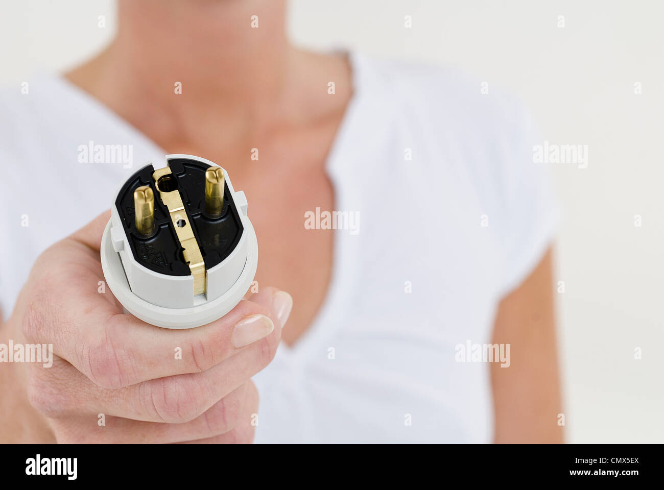 Young woman electric plug, close up Stock Photo - Alamy