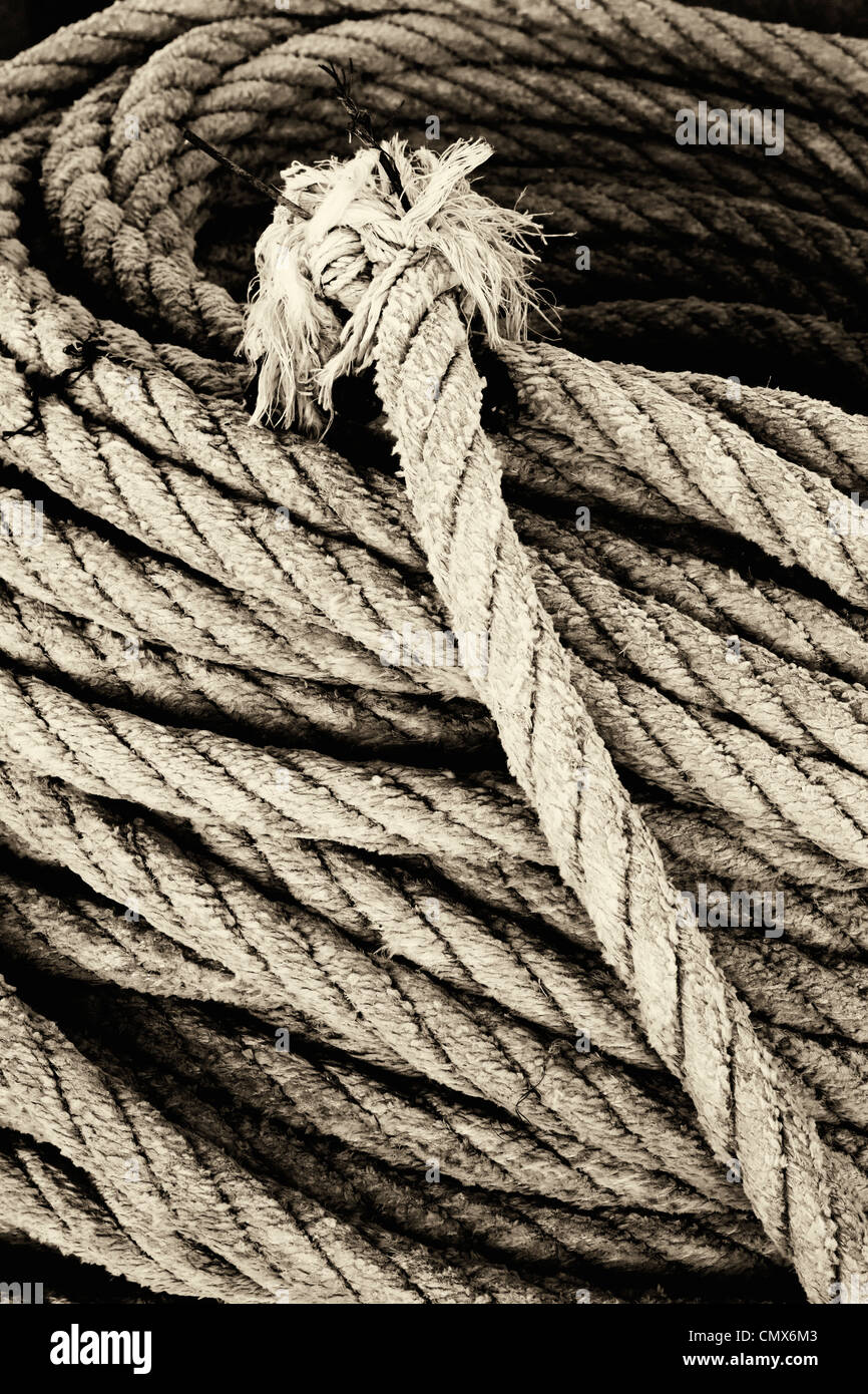 Coil of rope with ragged end Stock Photo - Alamy