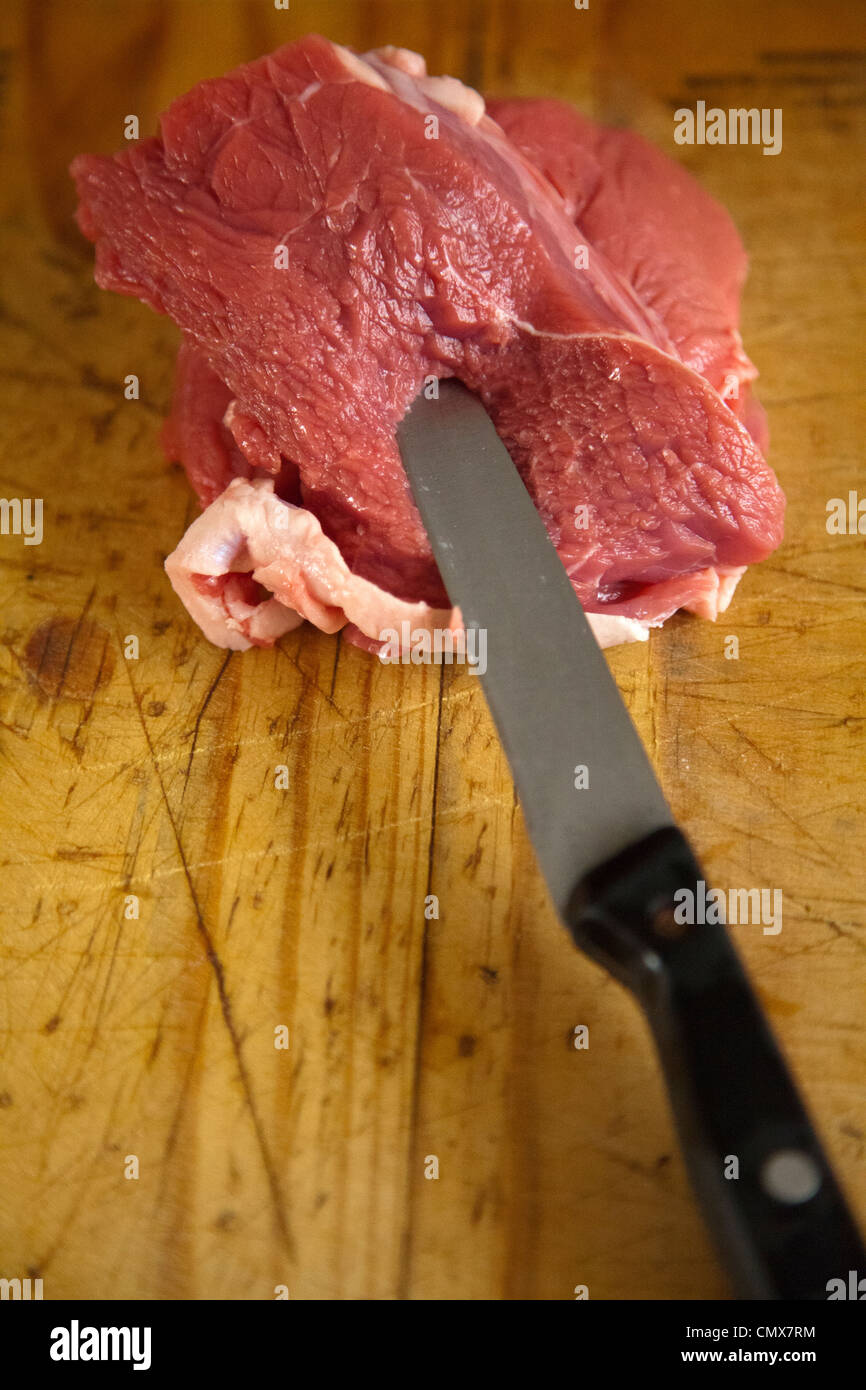Knife in fillet of beef Stock Photo - Alamy