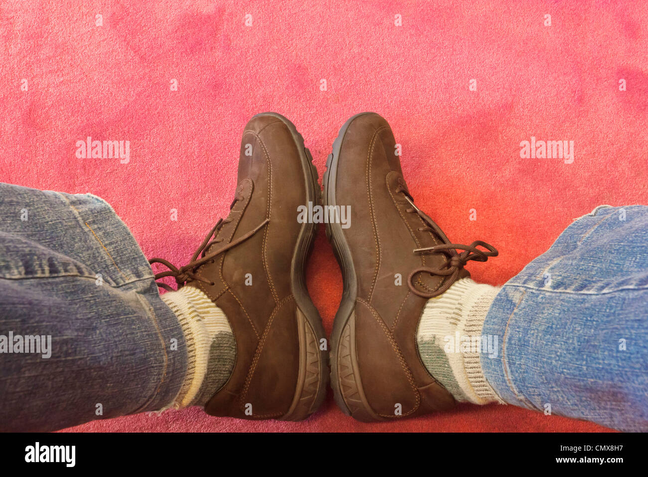 Photographer's view of own feet wearing brown shoes Stock Photo - Alamy
