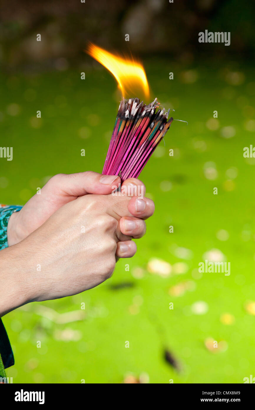 Mid adult woman burning incence hi-res stock photography and images - Alamy