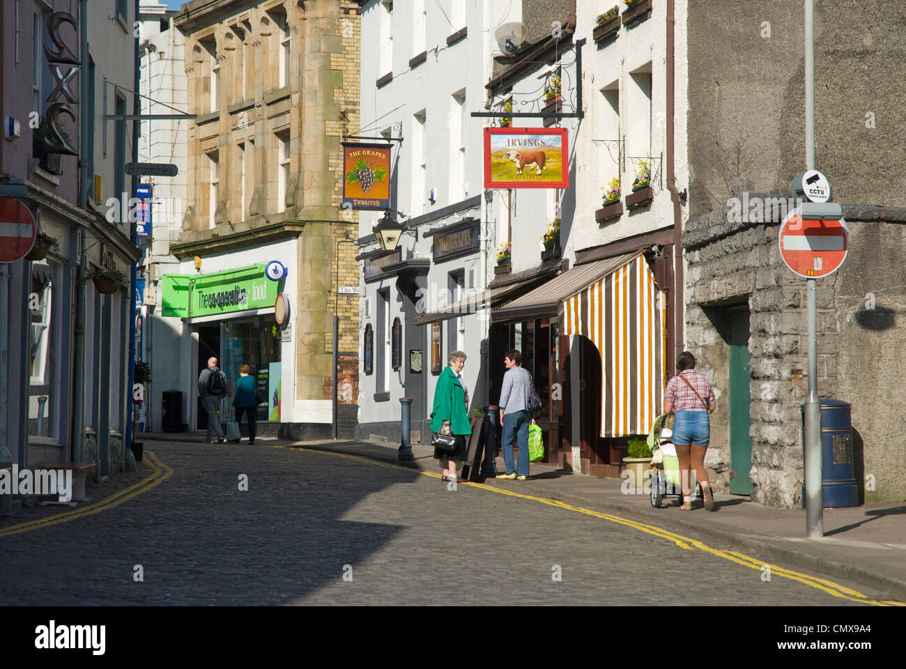 Shops and shoppers in Market Street, Ulverston, Cumbria UK Stock Photo ...