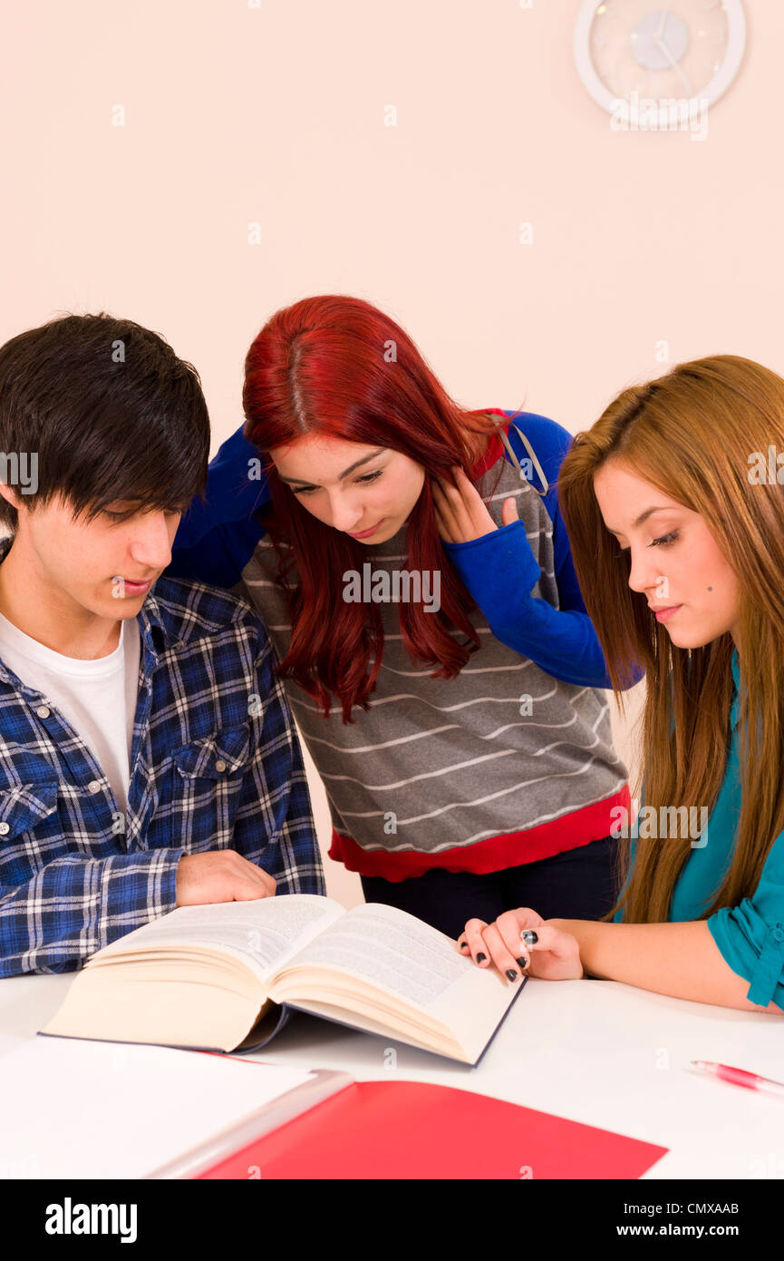 Teamwork in classroom, three concentrated students Stock Photo - Alamy