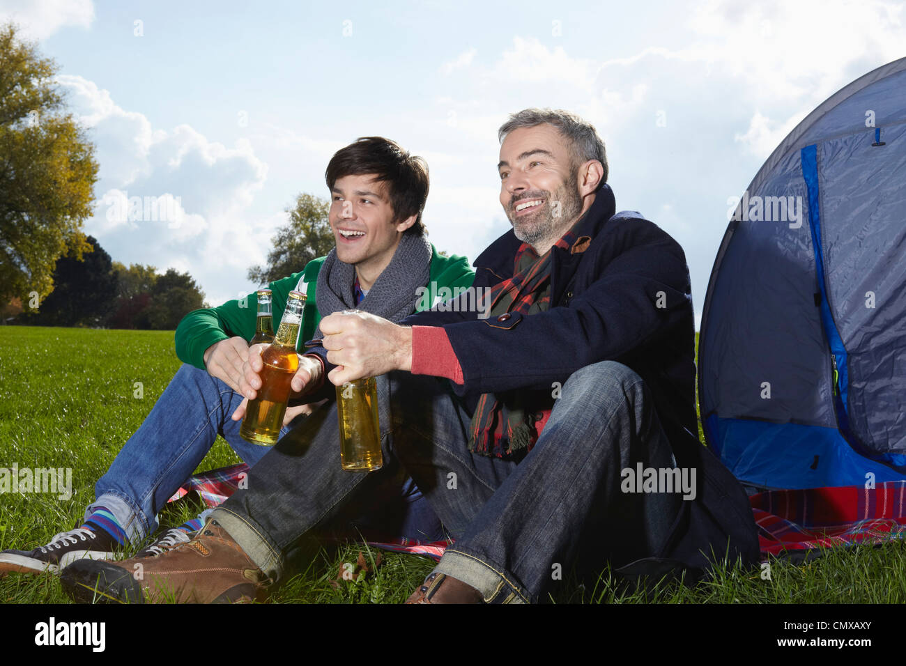 Germany, Cologne, Man drinking beer in park, smiling Stock Photo - Alamy