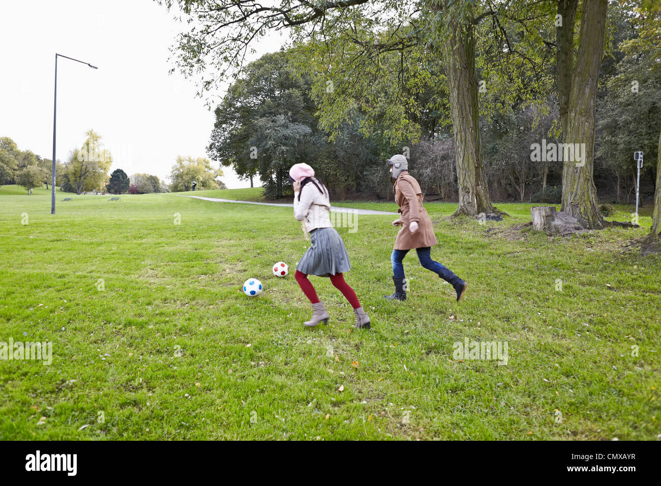 Germany, Cologne, Woman playing soccer in park Stock Photo - Alamy