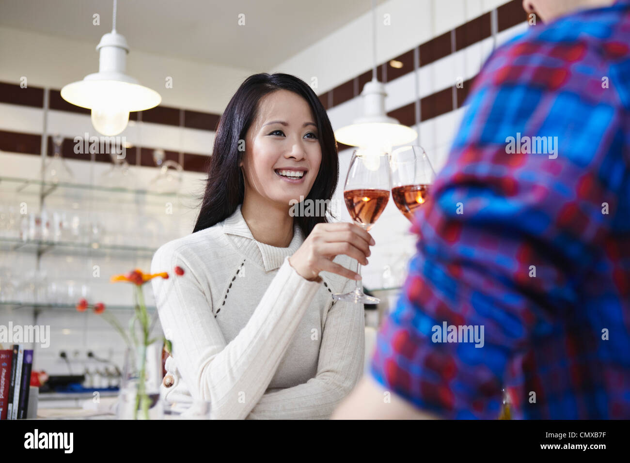 Germany, Cologne, Young couple drinking wine, smiling Stock Photo - Alamy