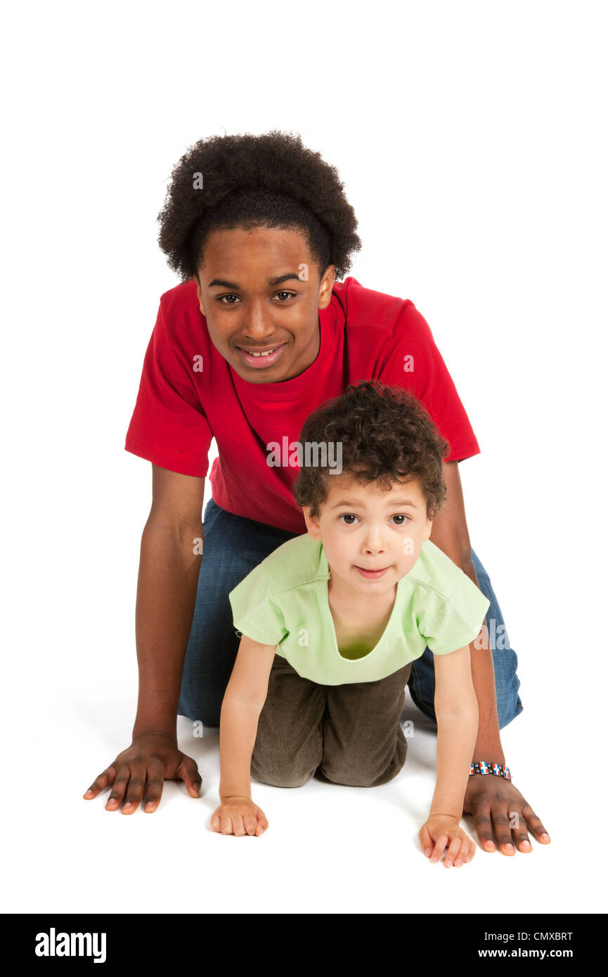 Two multi-cultural half brothers sitting in studio Stock Photo - Alamy