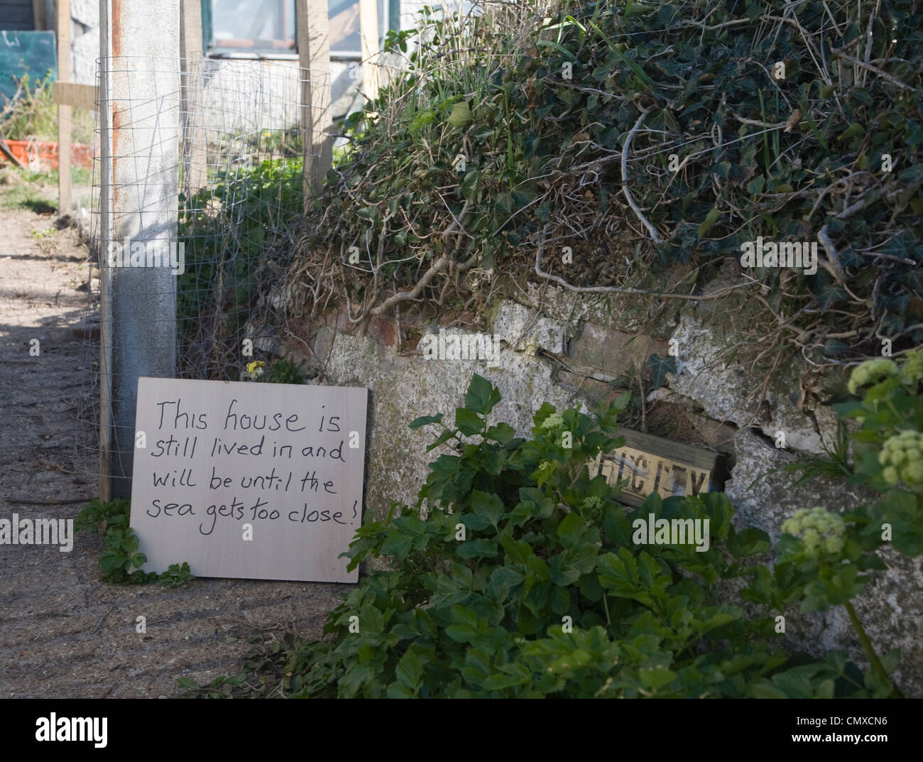 Rapid coastal erosion Happisburgh Norfolk England - hand written sign ...