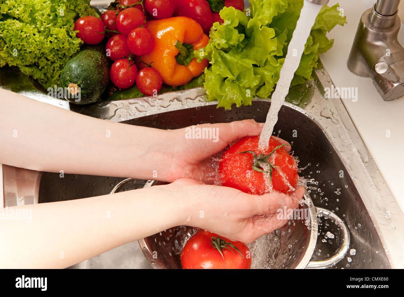 Vegetables washing, splashing water, fresh salad preparation Stock ...