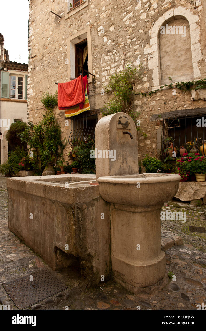 A closeup of an old, medieval water fountain in a village of Saint-Paul ...