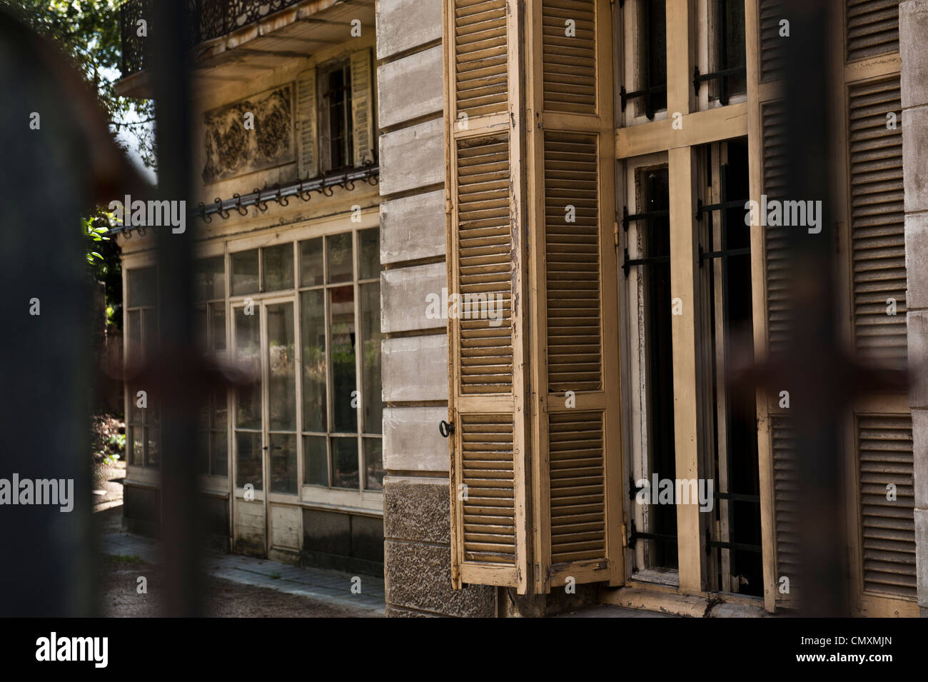 POV shot taken behind a gate to capture an open apartment building ...