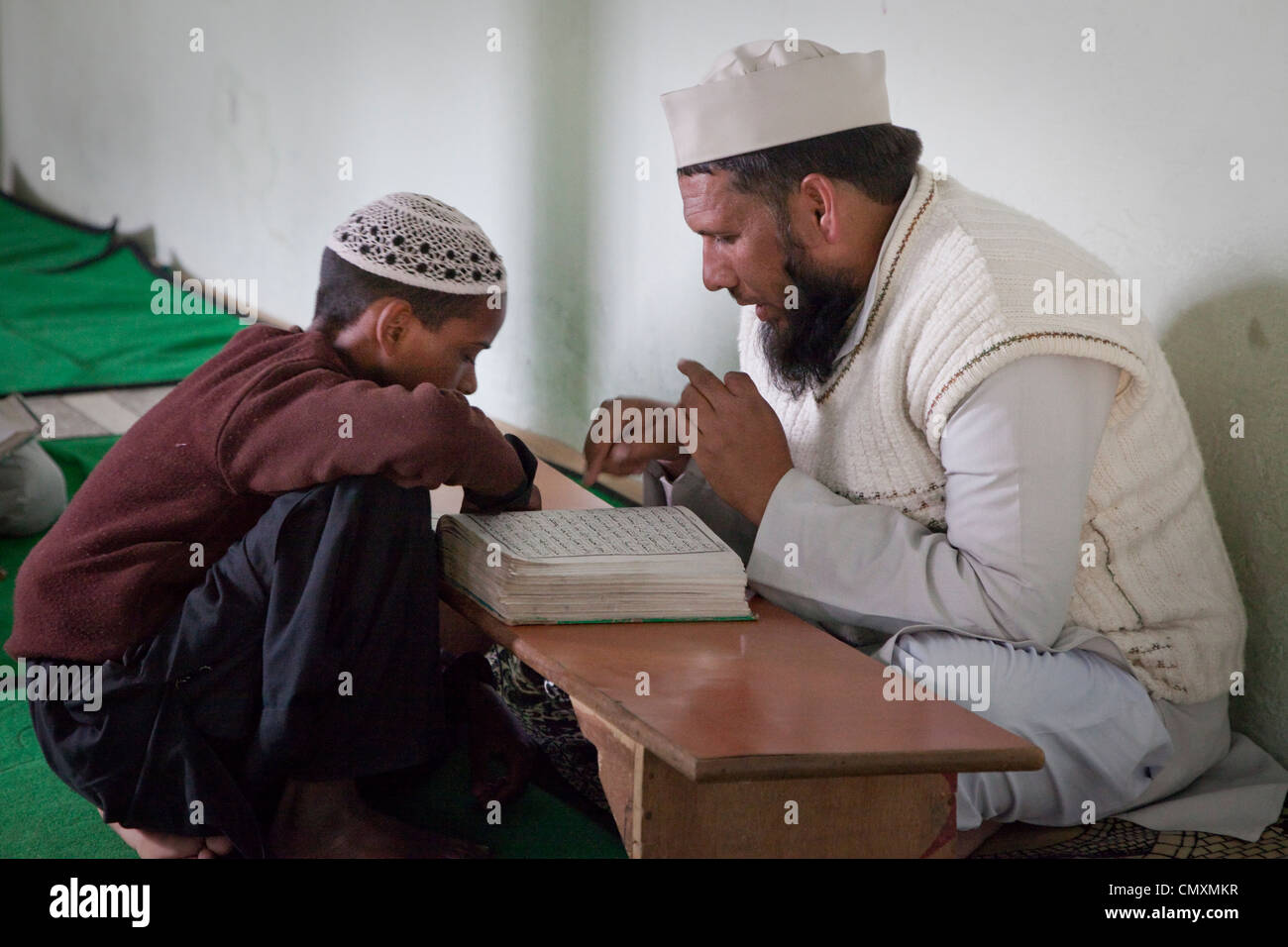 Imam Leads Madrasa Student through his Koranic Reading Lesson, Madrasa ...