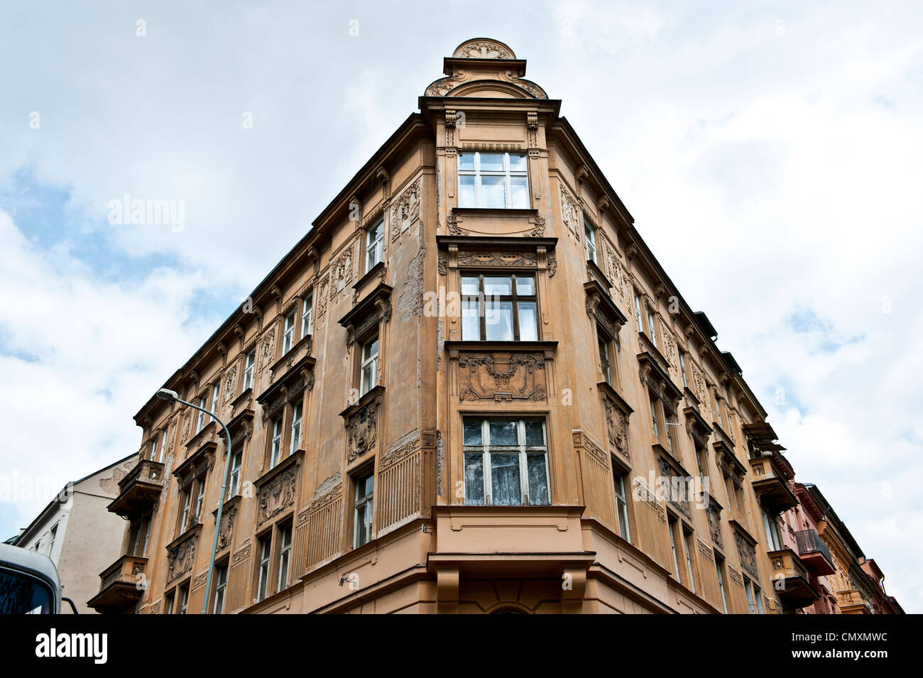 A cloudy, blue sky draping a large residential building in Czech ...