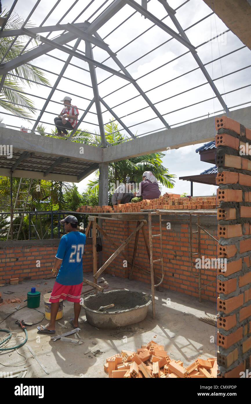 Burmese builders working on a house in Phuket Thailand Stock Photo - Alamy