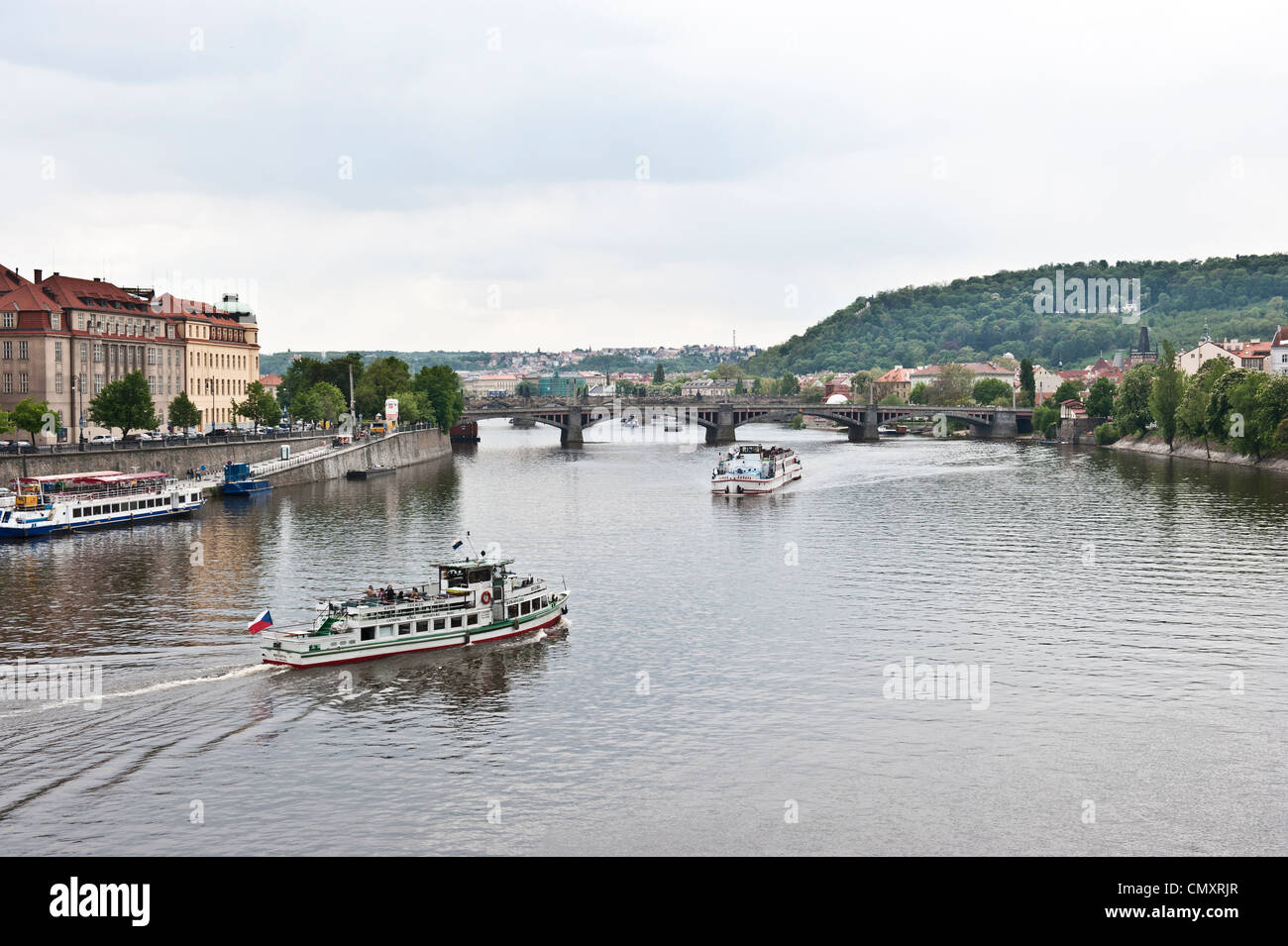 A long shot of boats sailing down the tranquil river underneath the ...