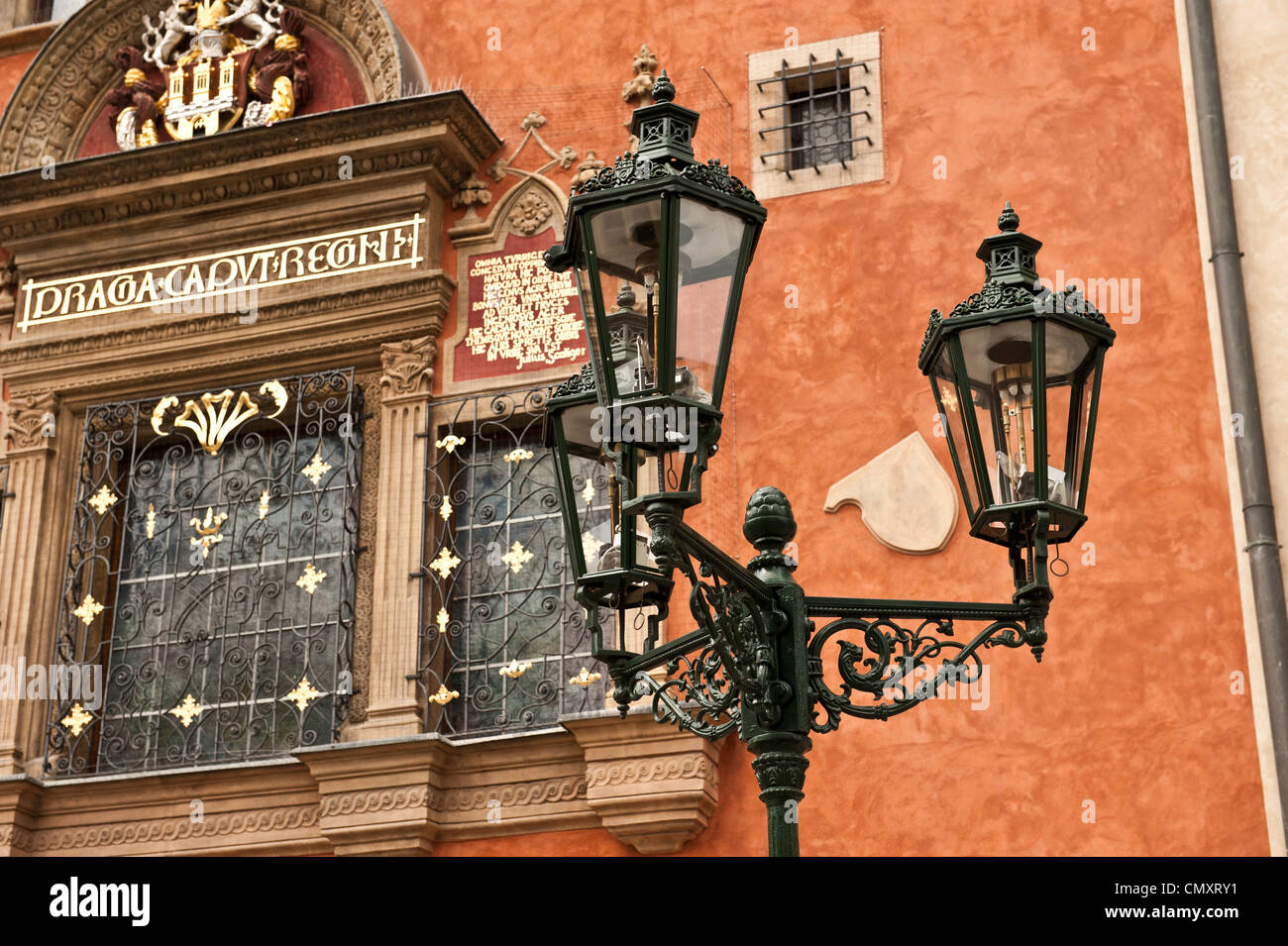 A trio lamp post located outside of a beautiful, classic European ...