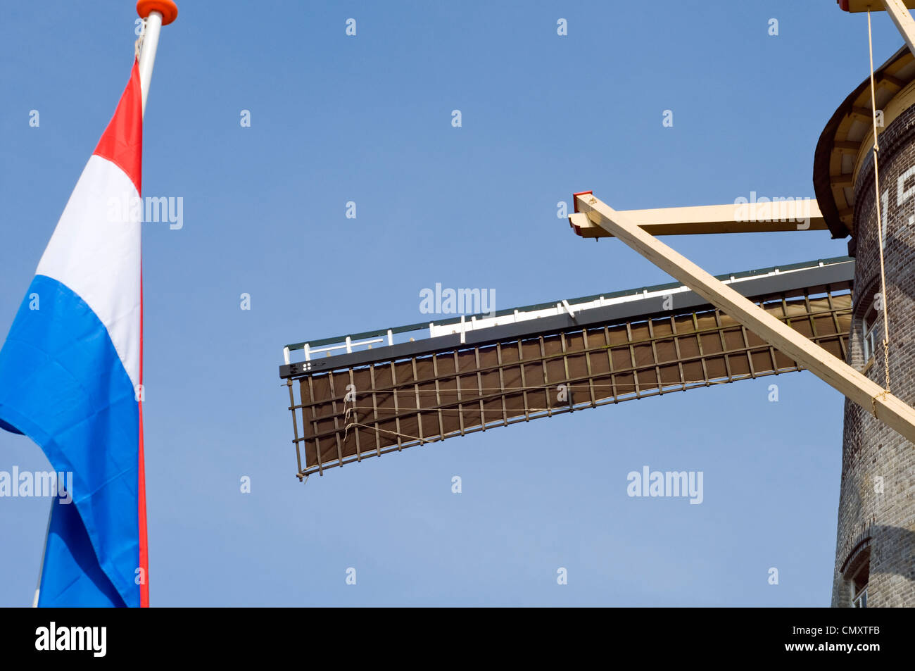The Dutch flag flying in front of a windmill in the Netherlands Stock ...