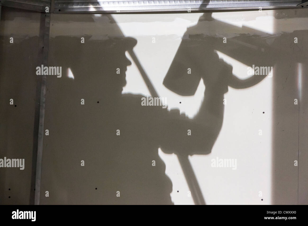 Shadow of worker on construction site Stock Photo - Alamy