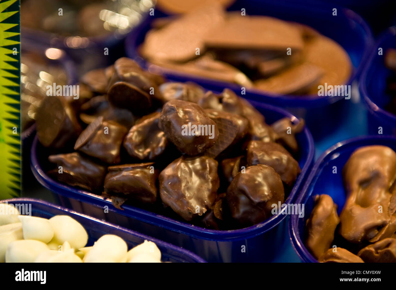Decadent looking chocolate candy enticingly placed in a blue tray ...